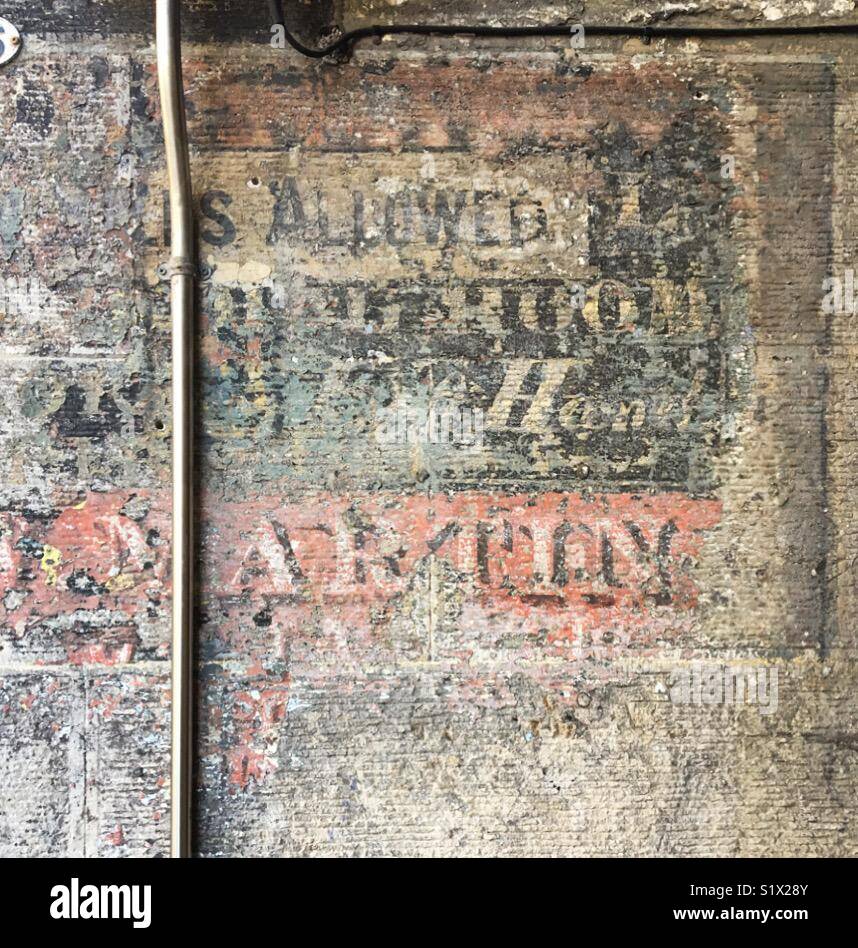 Remnants of an old painted sign on a wall Stock Photo - Alamy