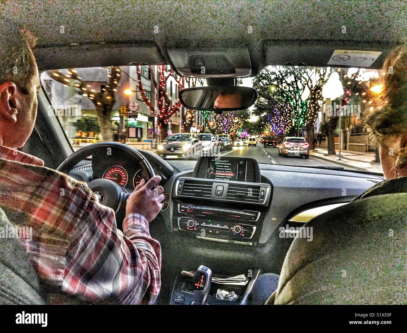View through car windscreen to the road ahead from the back seat, with ...