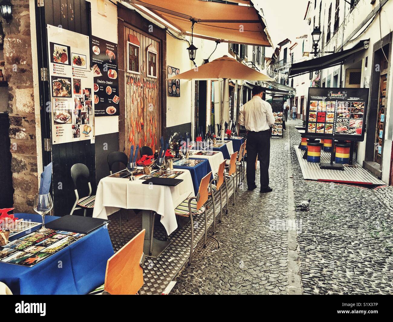 Street scene, with a restaurant and showing the painted doors art ...