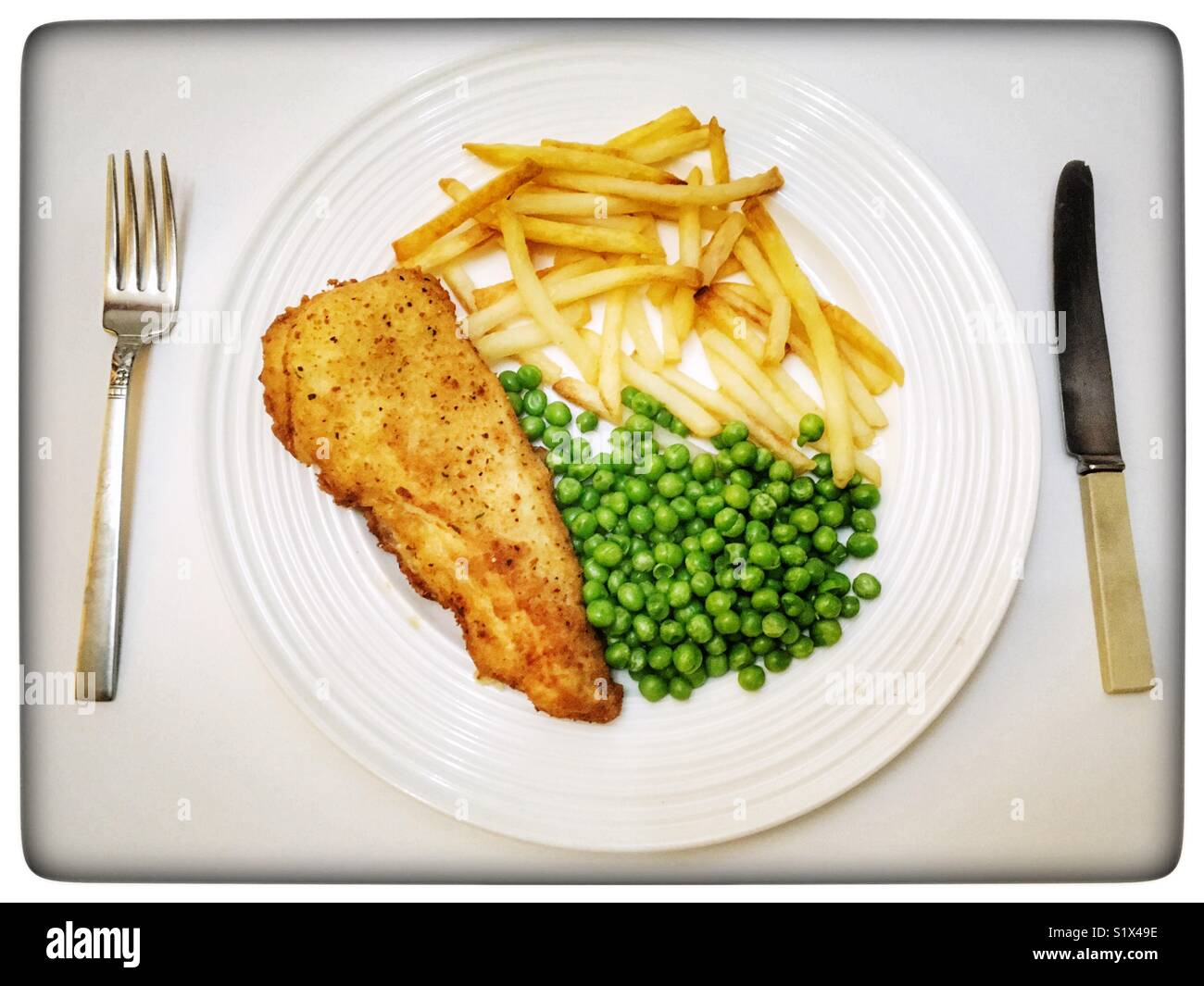 Seachill lightly dusted Scottish Haddock, chips and peas Stock Photo ...