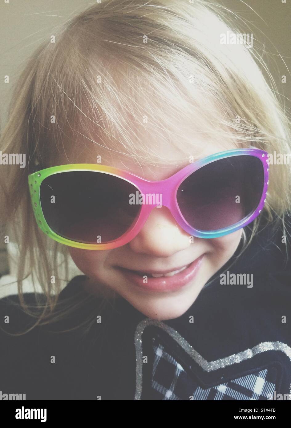 Child with rainbow colored sunglasses Stock Photo - Alamy