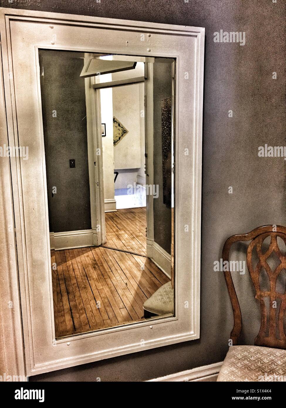 Mirror reflecting a wooden floor and staircase Stock Photo - Alamy