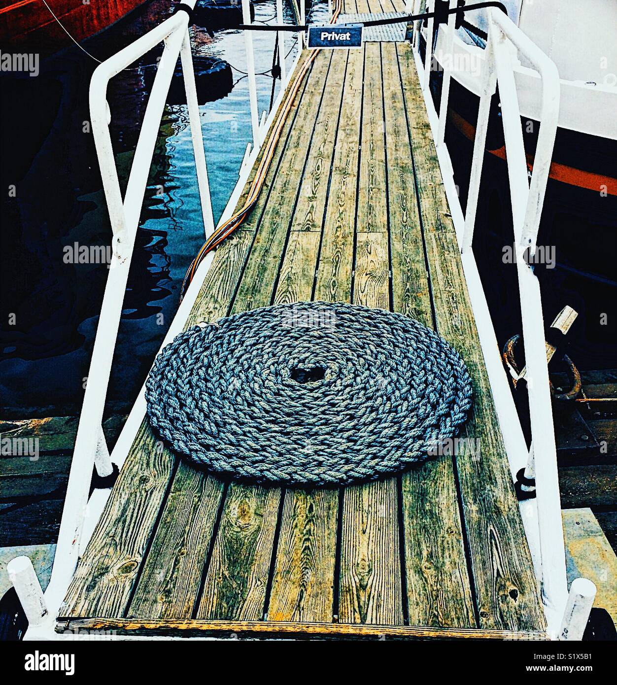Coil of rope on private wooden boat gangway, Sweden, Scandinavia Stock ...