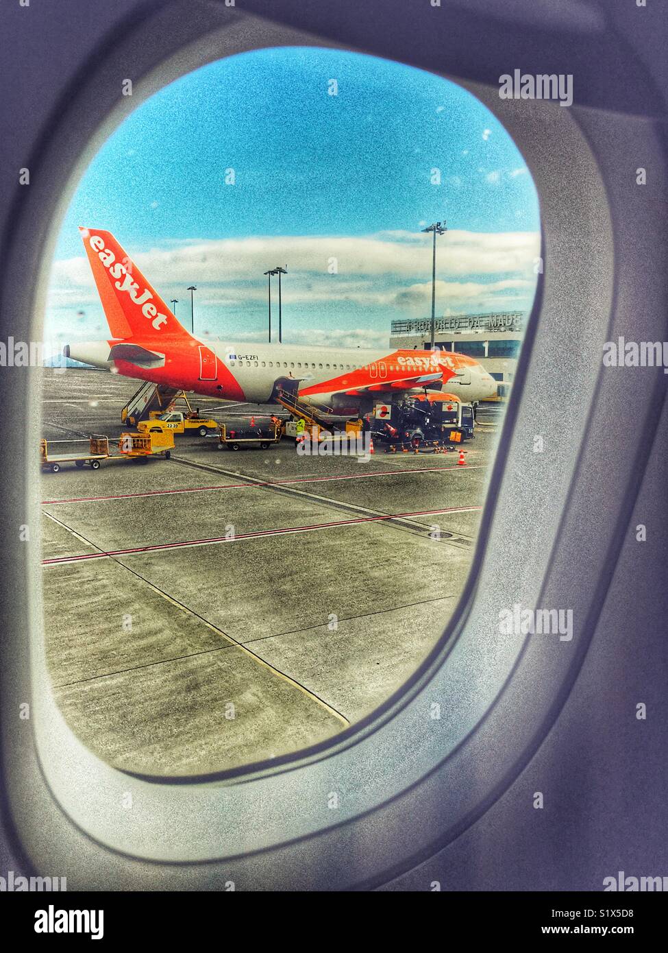 View through the window of an aeroplane to an EasyJet aeroplane on the ...
