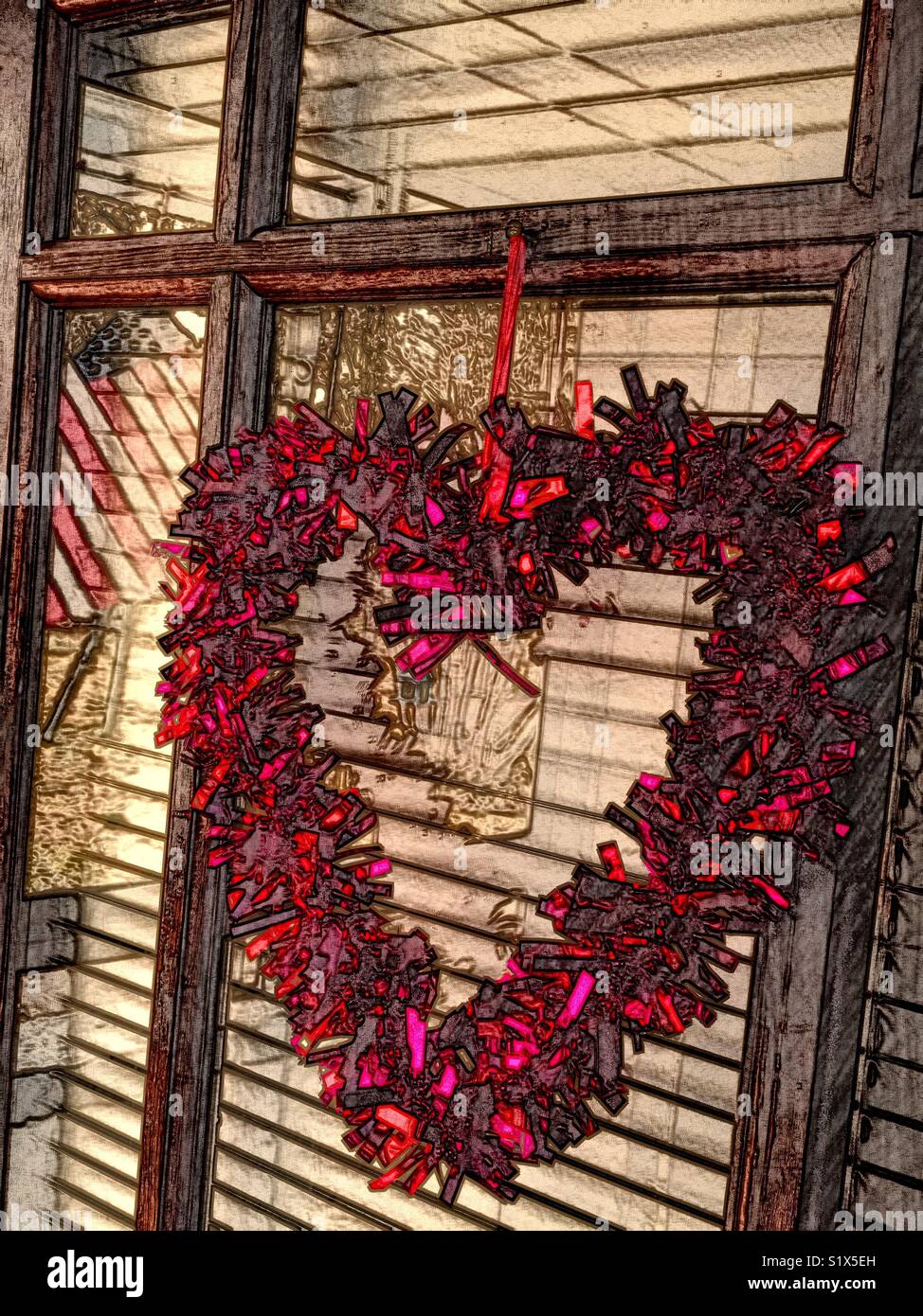 A Valentine heart, which decorates an old wood and glass door, is ...