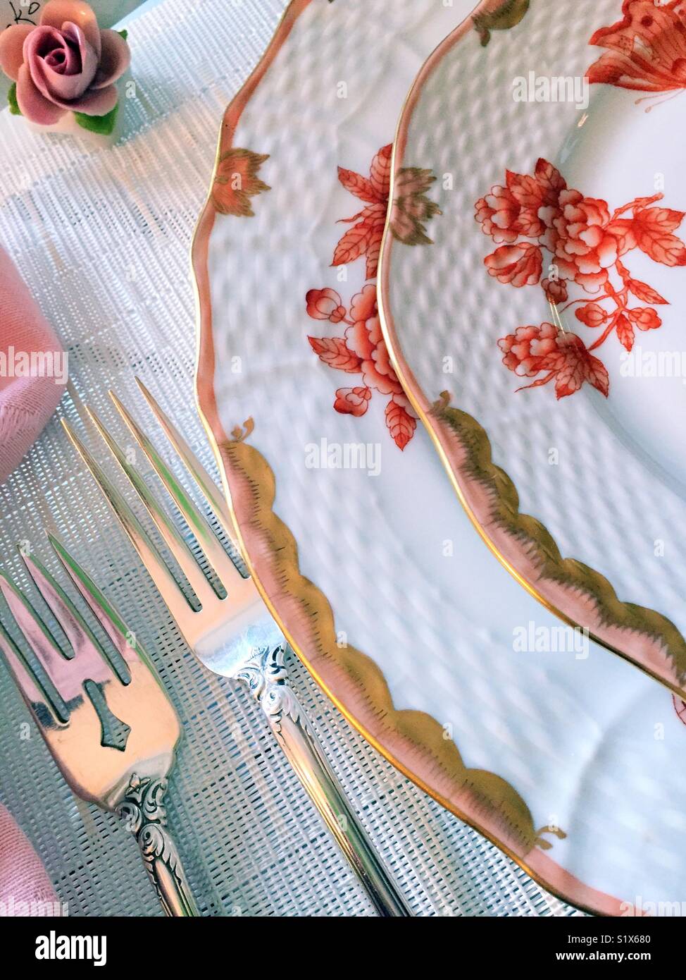 Table setting with fine china plates and sterling silver forks Stock ...