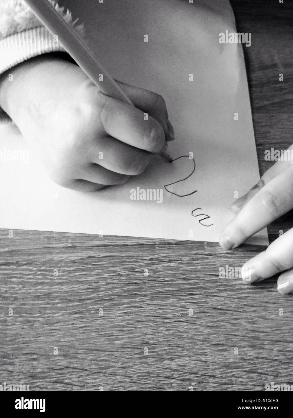 Black child writing with pencil hi-res stock photography and images - Alamy