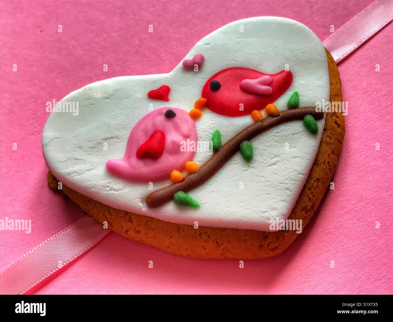 Love birds on the icing of a heart shaped gingerbread cookie Stock ...