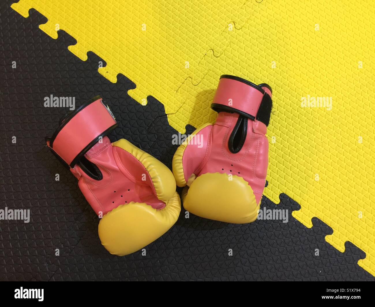 Colorful boxing gloves on floor Stock Photo - Alamy