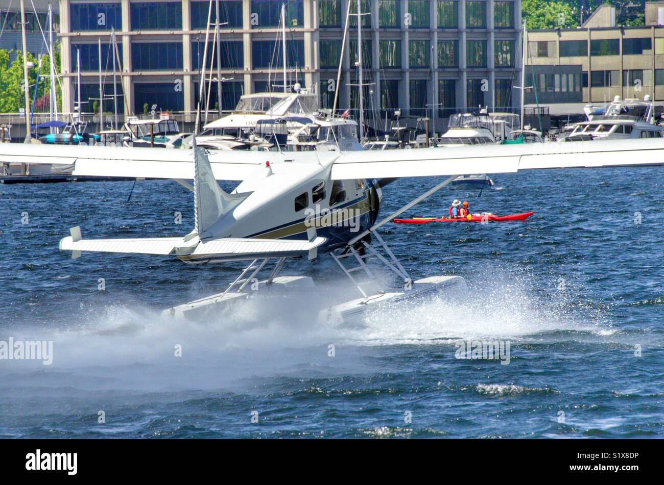Kayaking in front of a float plane on Lake Union in Seattle Washington ...