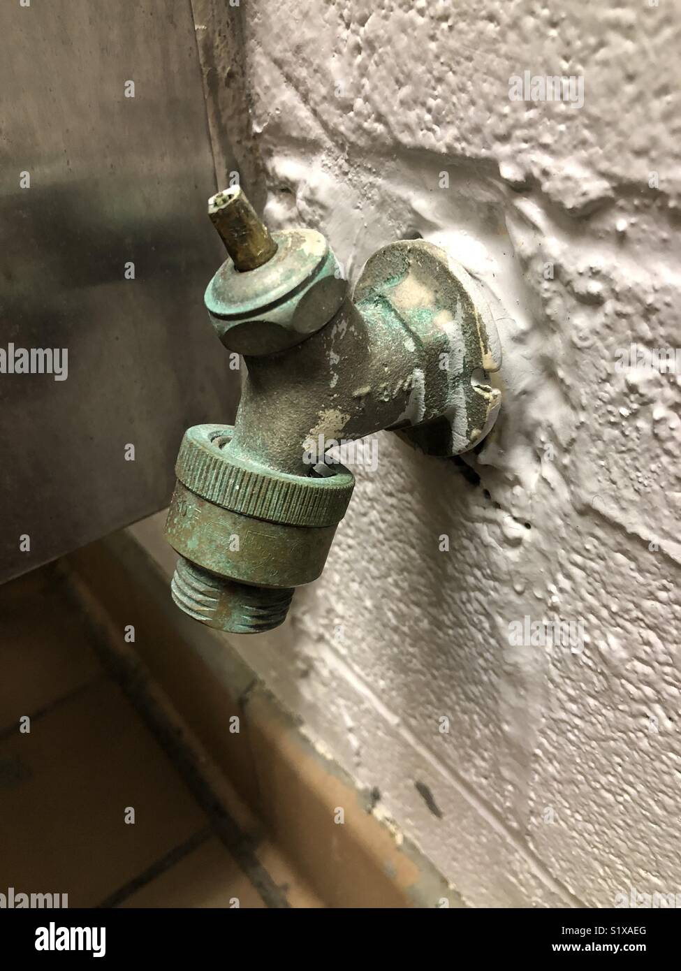 Antique water receptacle hidden in a bathroom stall Stock Photo - Alamy