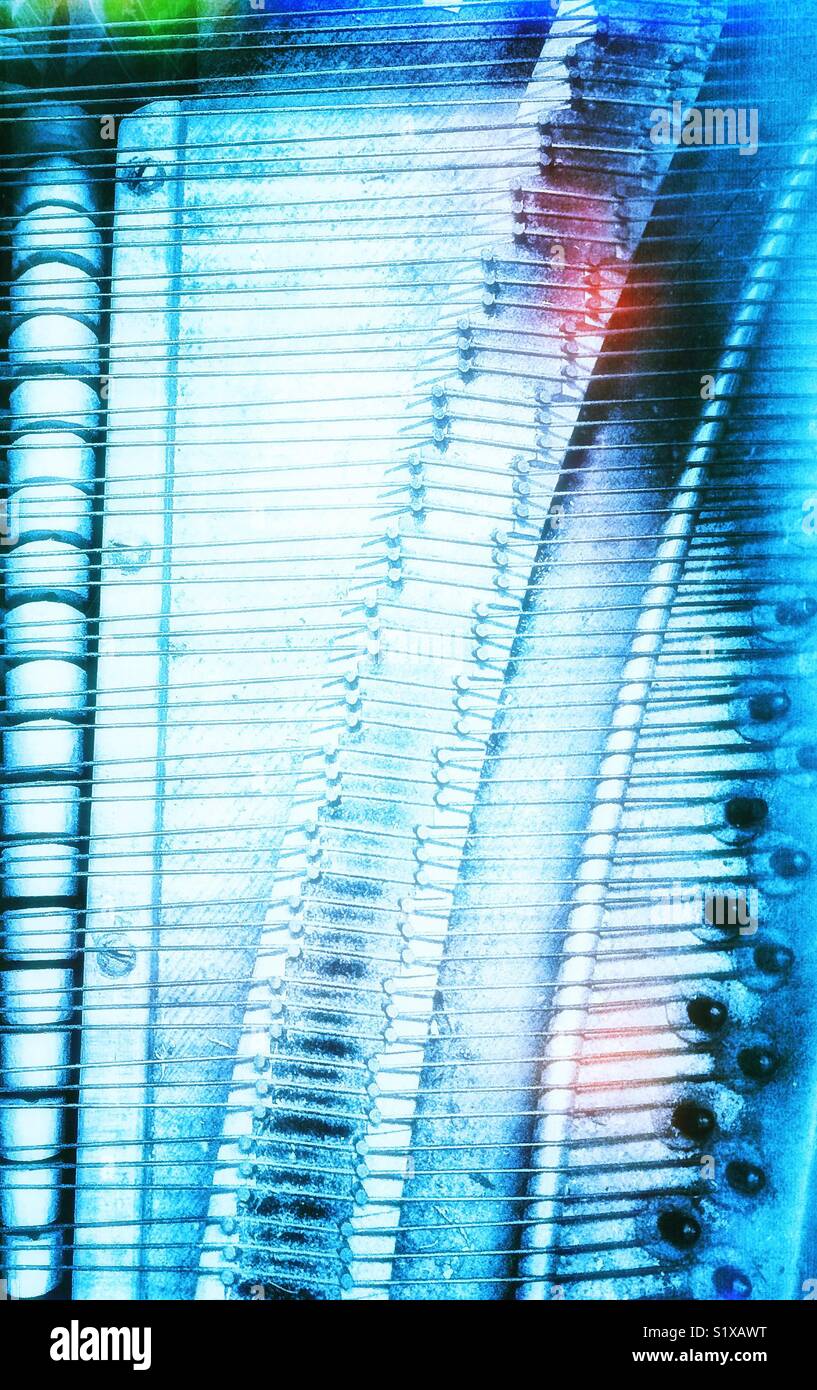 Close up of interior of upright piano showing strings and structure ...