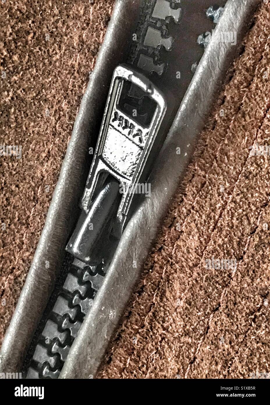 A zip on brown leather Stock Photo - Alamy