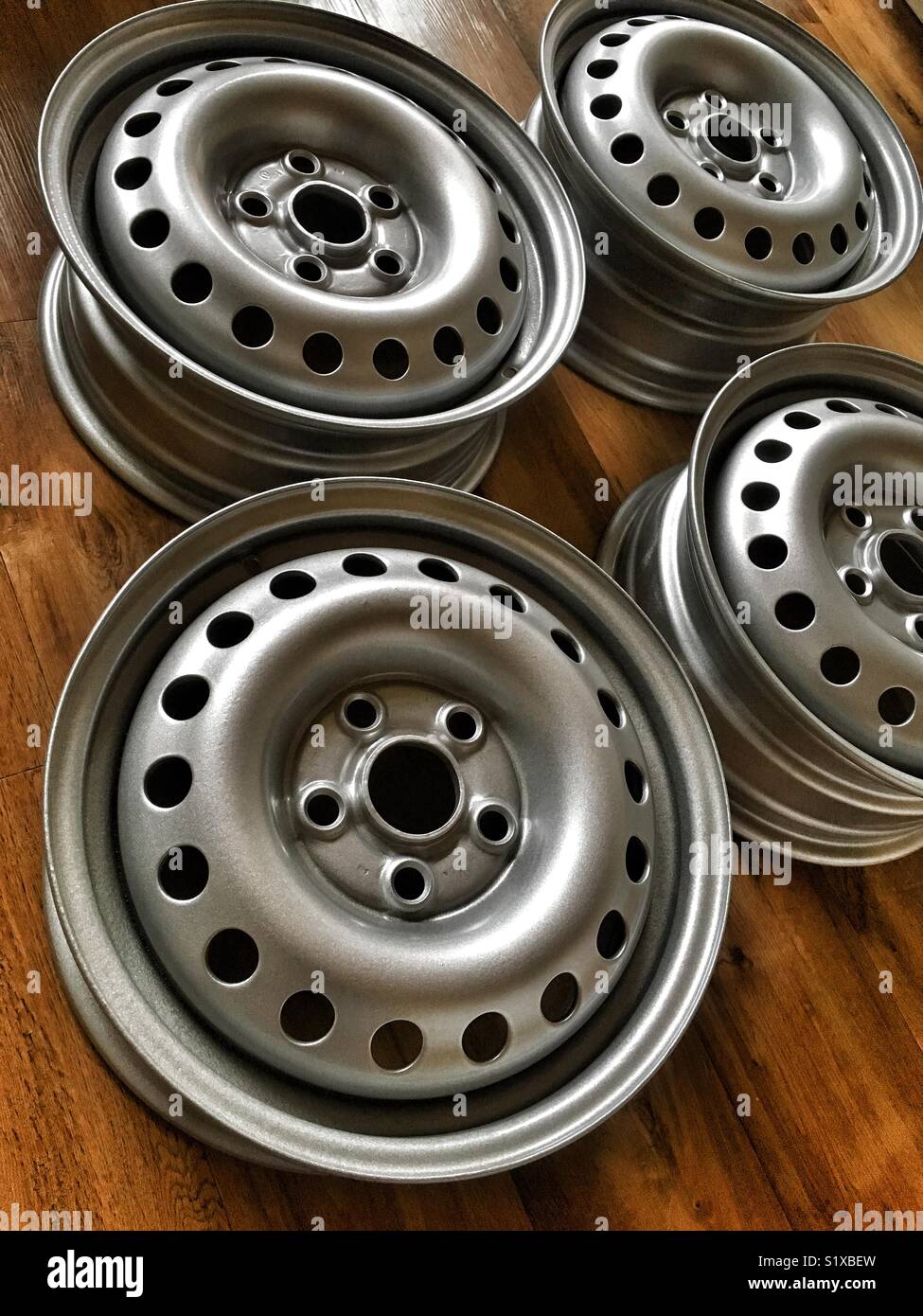 Steel car wheels waiting for tyres fitted Stock Photo - Alamy