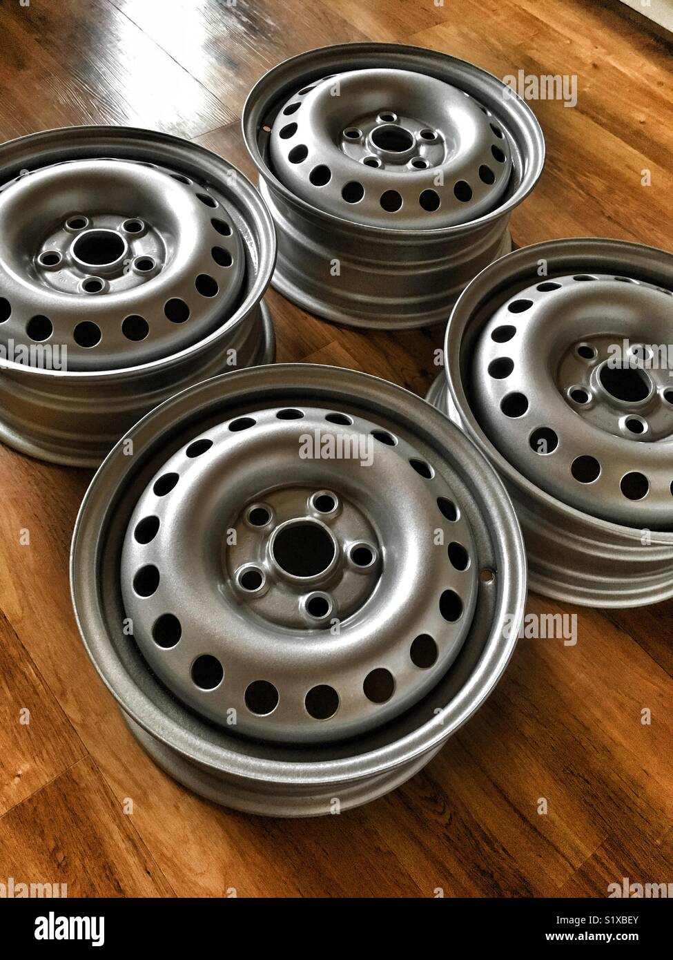 Steel car wheels waiting for tyres fitted Stock Photo - Alamy