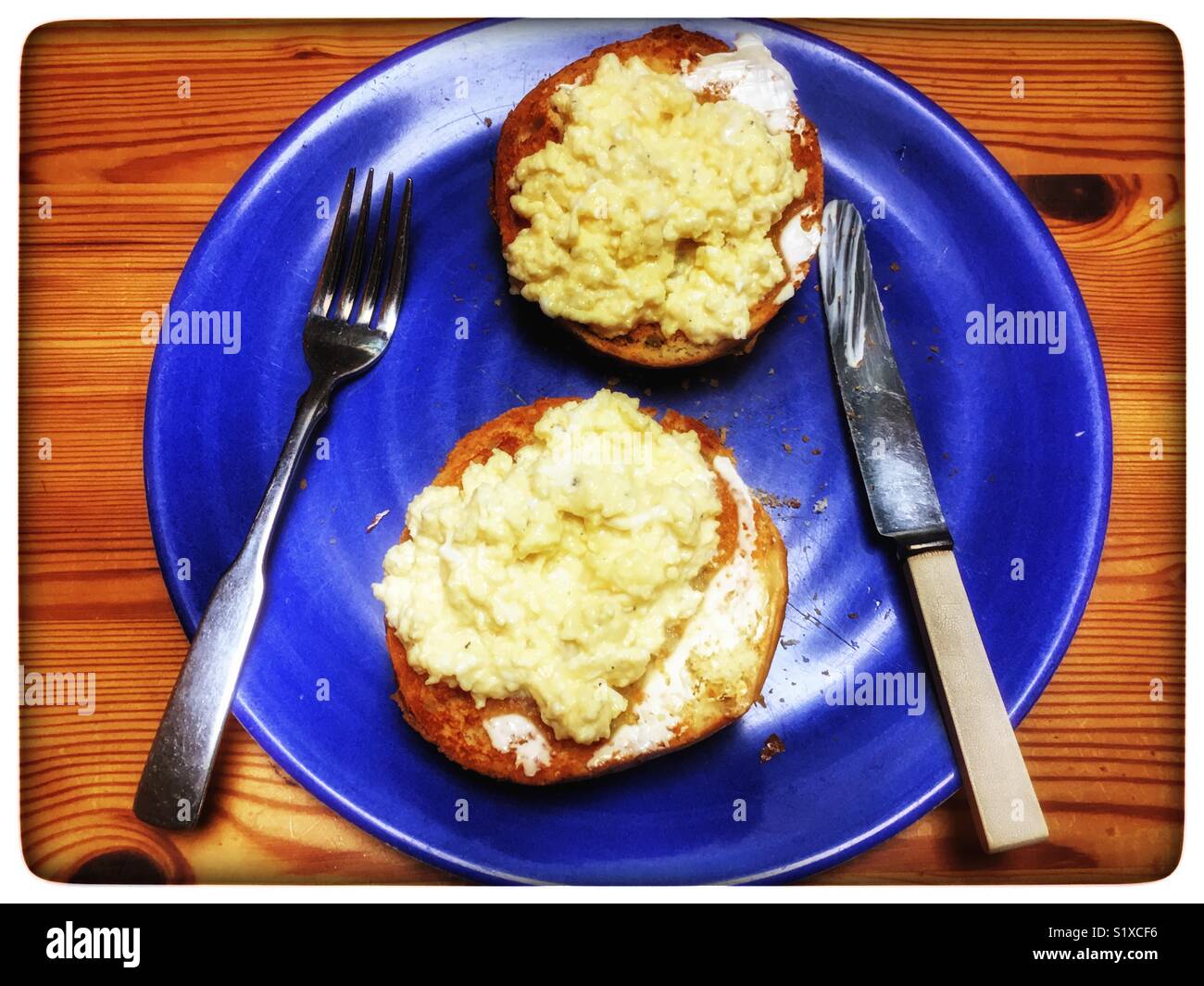 Scrambled eggs on toasted bread roll Stock Photo - Alamy