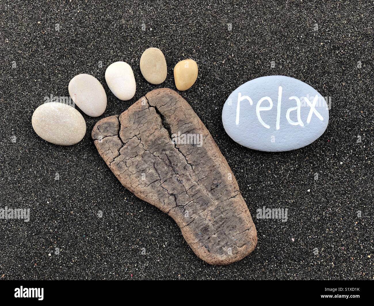 Relax, conceptual stones composition over black volcanic sand Stock ...