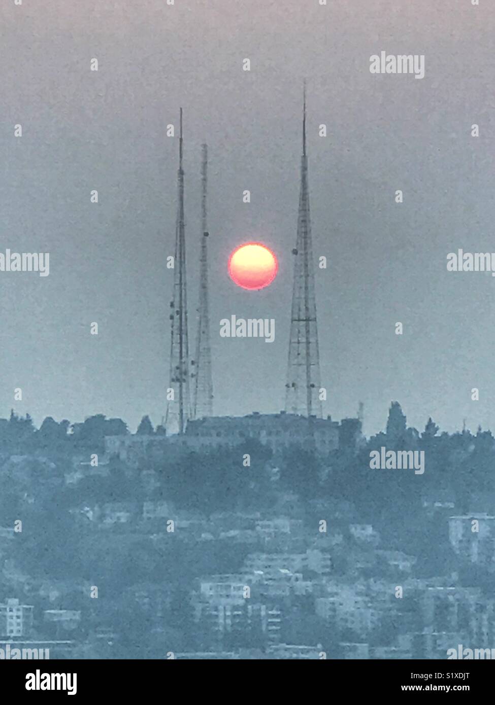 Sun centered between two towers at sunset. Seattle Washington Stock ...