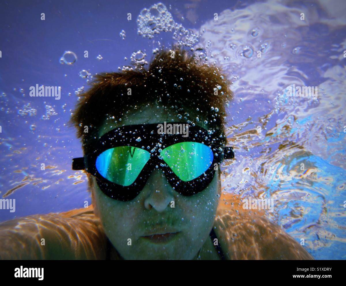 Underwater photo of lady swimming Stock Photo - Alamy