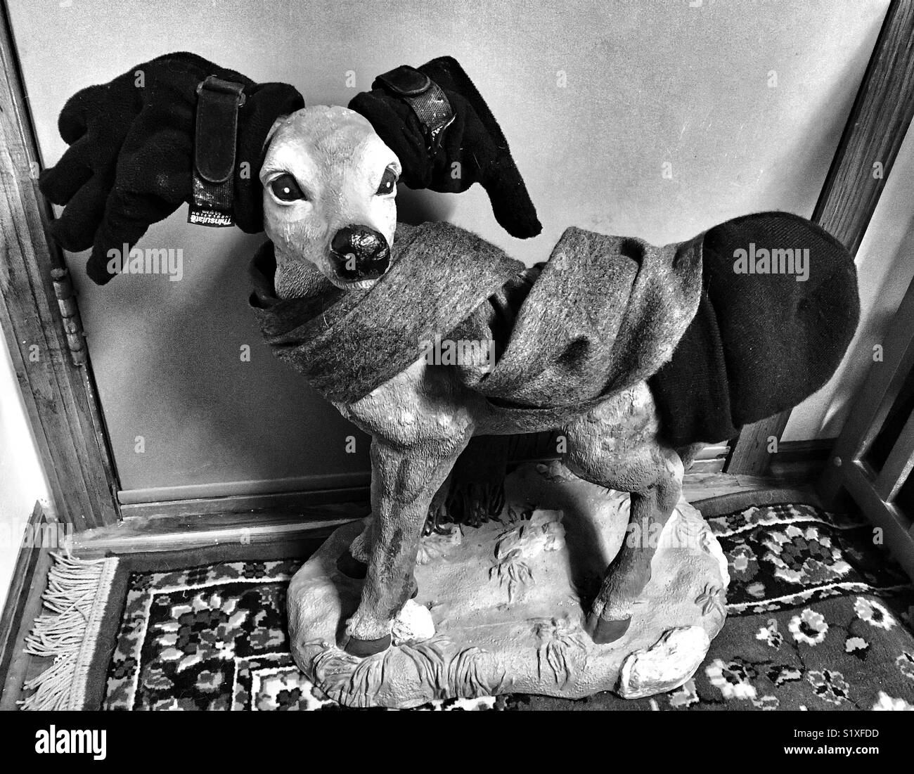 Deer fawn lawn ornament used as a drying rack in winter Stock Photo - Alamy
