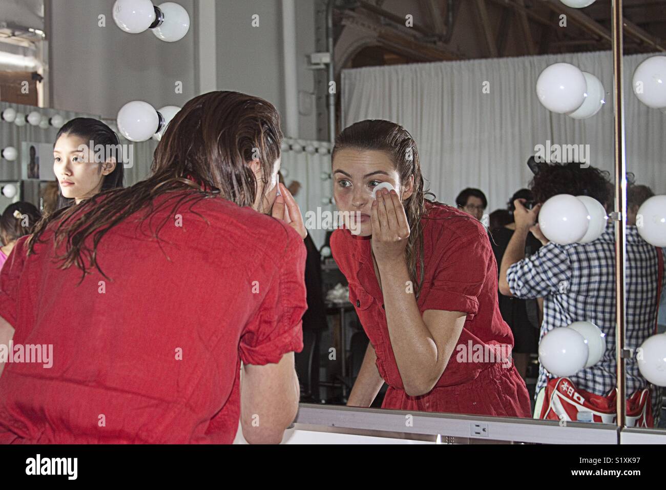 Skin care Fashion model removing her makeup after a fashion show Stock ...