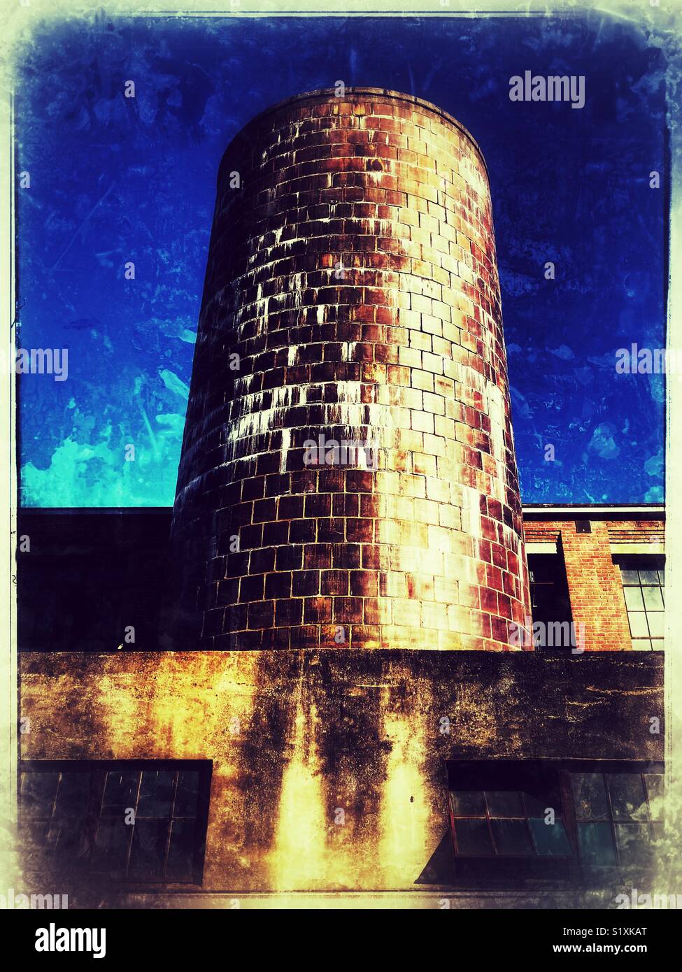 Round stack on an old mill building Stock Photo - Alamy