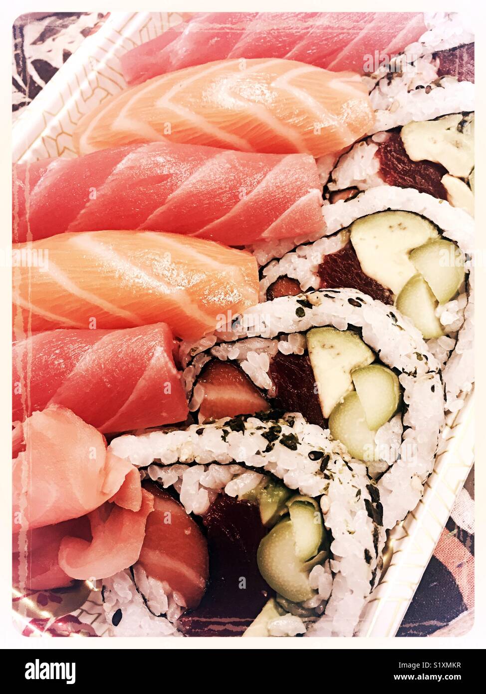 Fresh pieces of sushi and California roll from Japanese take out ...