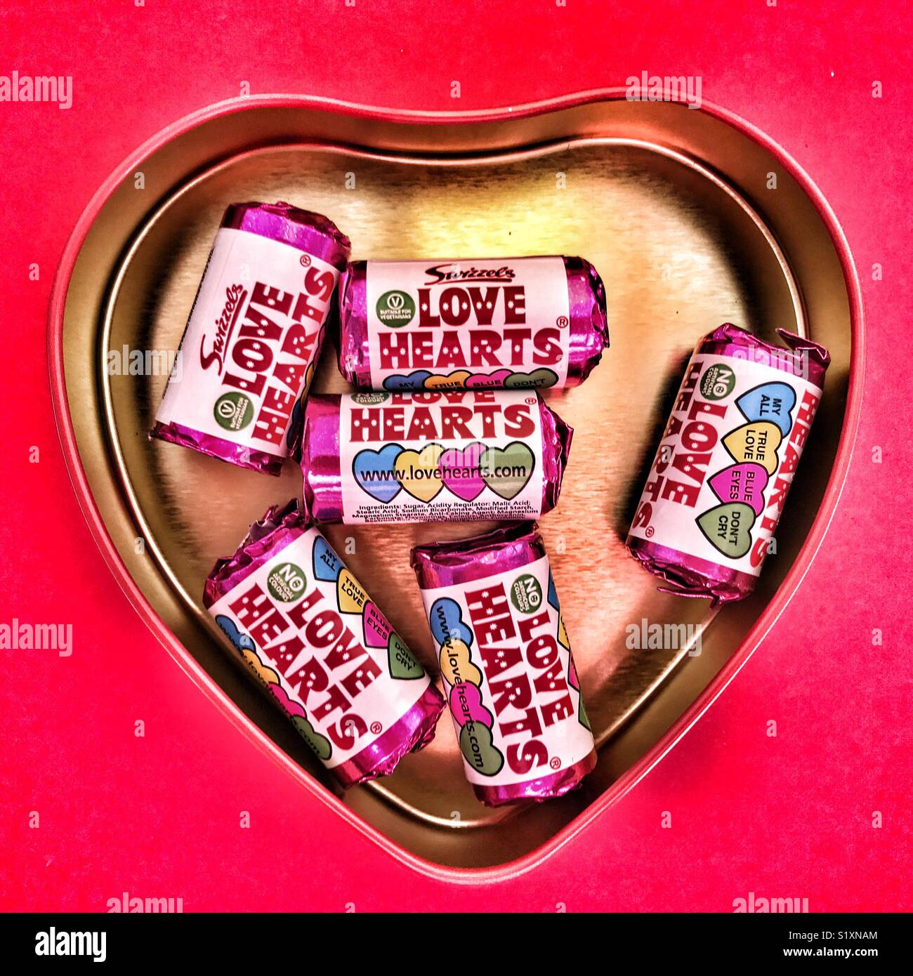 packets of Love Hearts in a heart shaped tin Stock Photo - Alamy