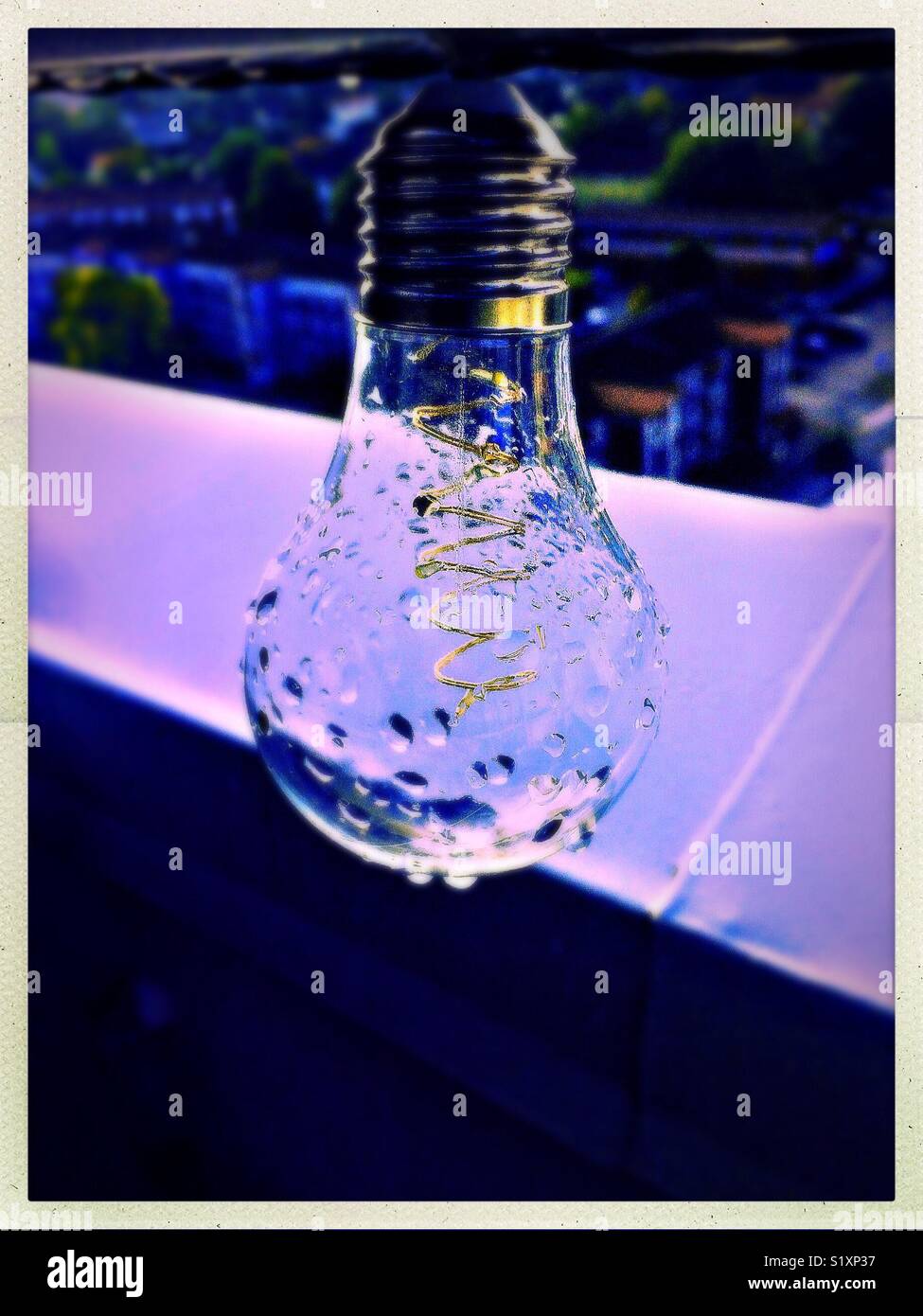 Wet lightbulb hanging on terrace Stock Photo - Alamy