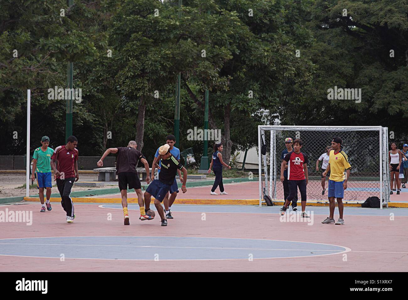 Group of boys playing football outdoors Stock Photo - Alamy