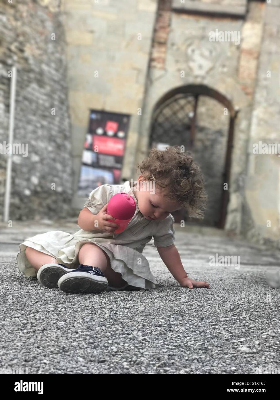 A kid looking on the ground Stock Photo - Alamy