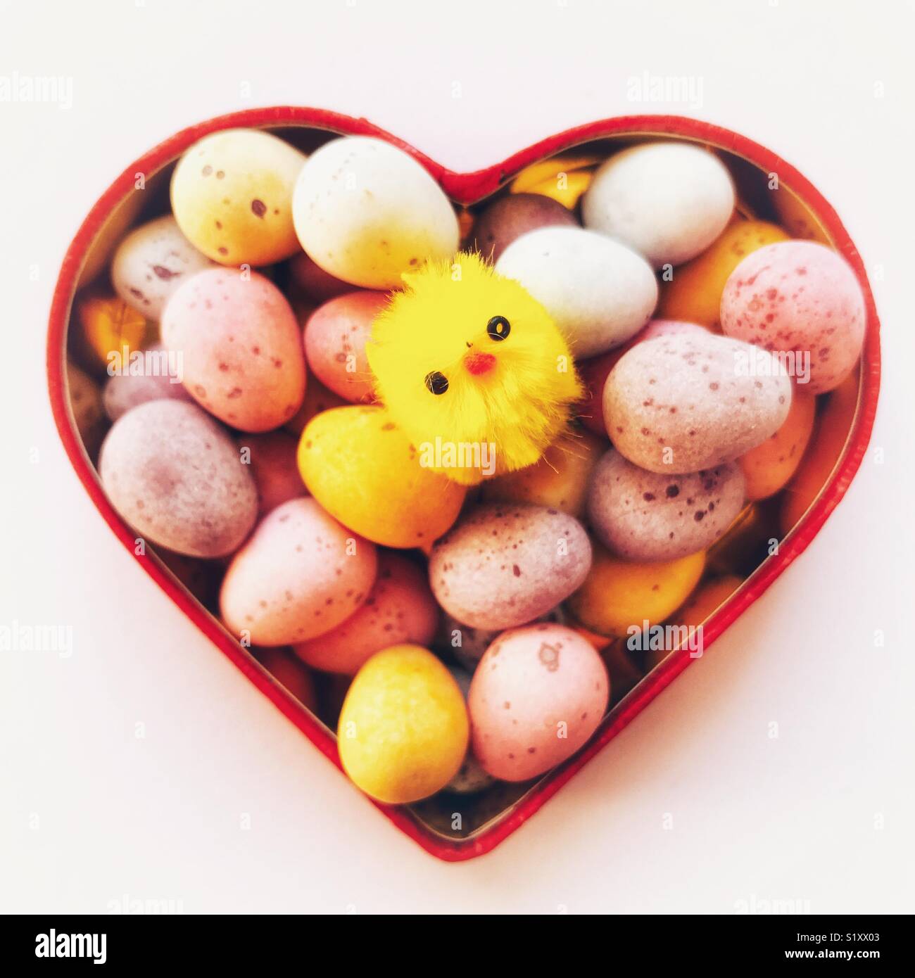 Chocolate Easter eggs in a heart shaped box with a tiny Easter chick ...