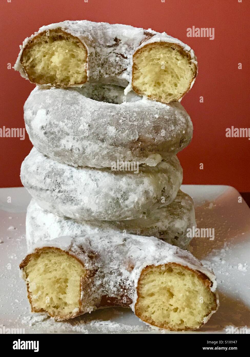 Stack of powdered donuts with one half on top and one on bottom Stock ...