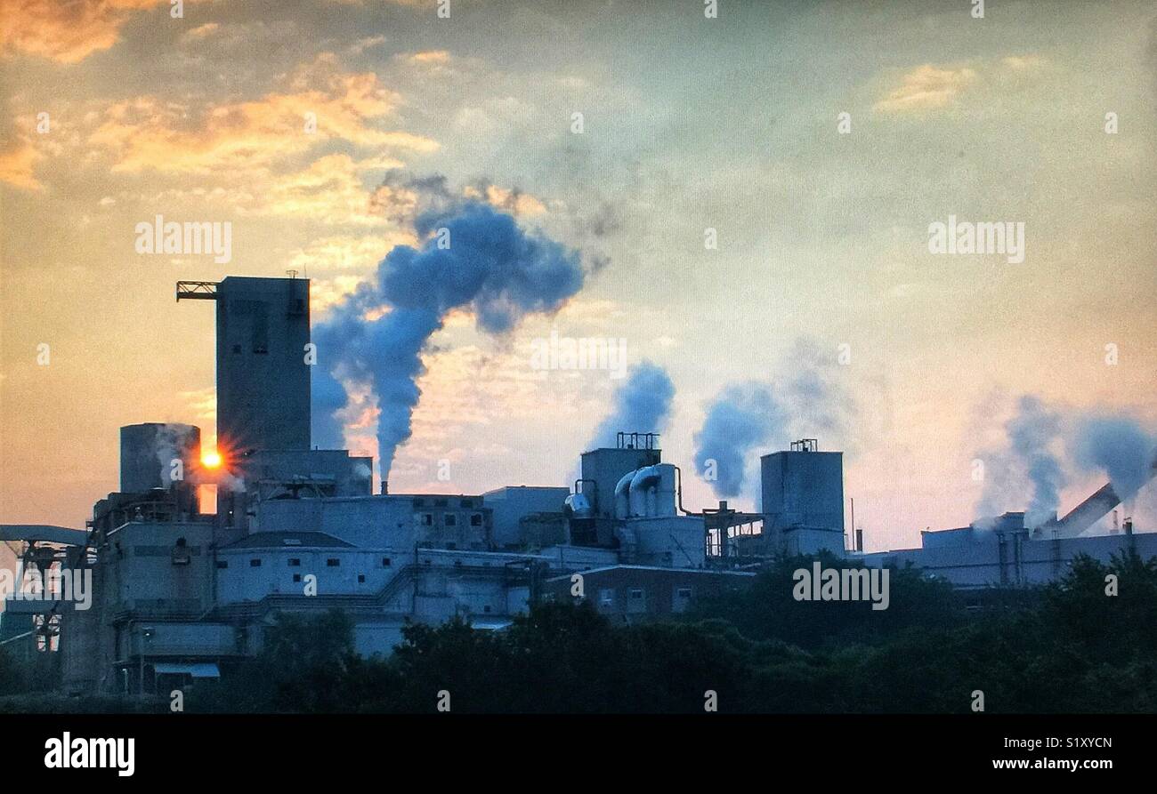 Manufacturing plant at sunrise Stock Photo - Alamy