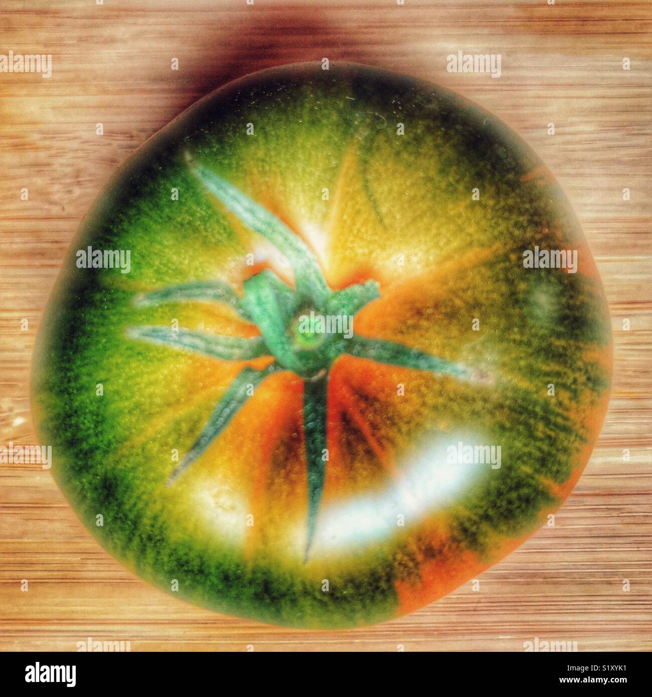 One green tomato above one red tomato hi-res stock photography and ...