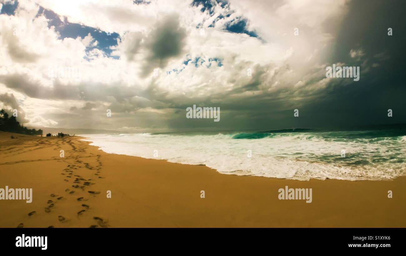 Storm clouds and rain showers over the ocean on the North Shore of Oahu ...