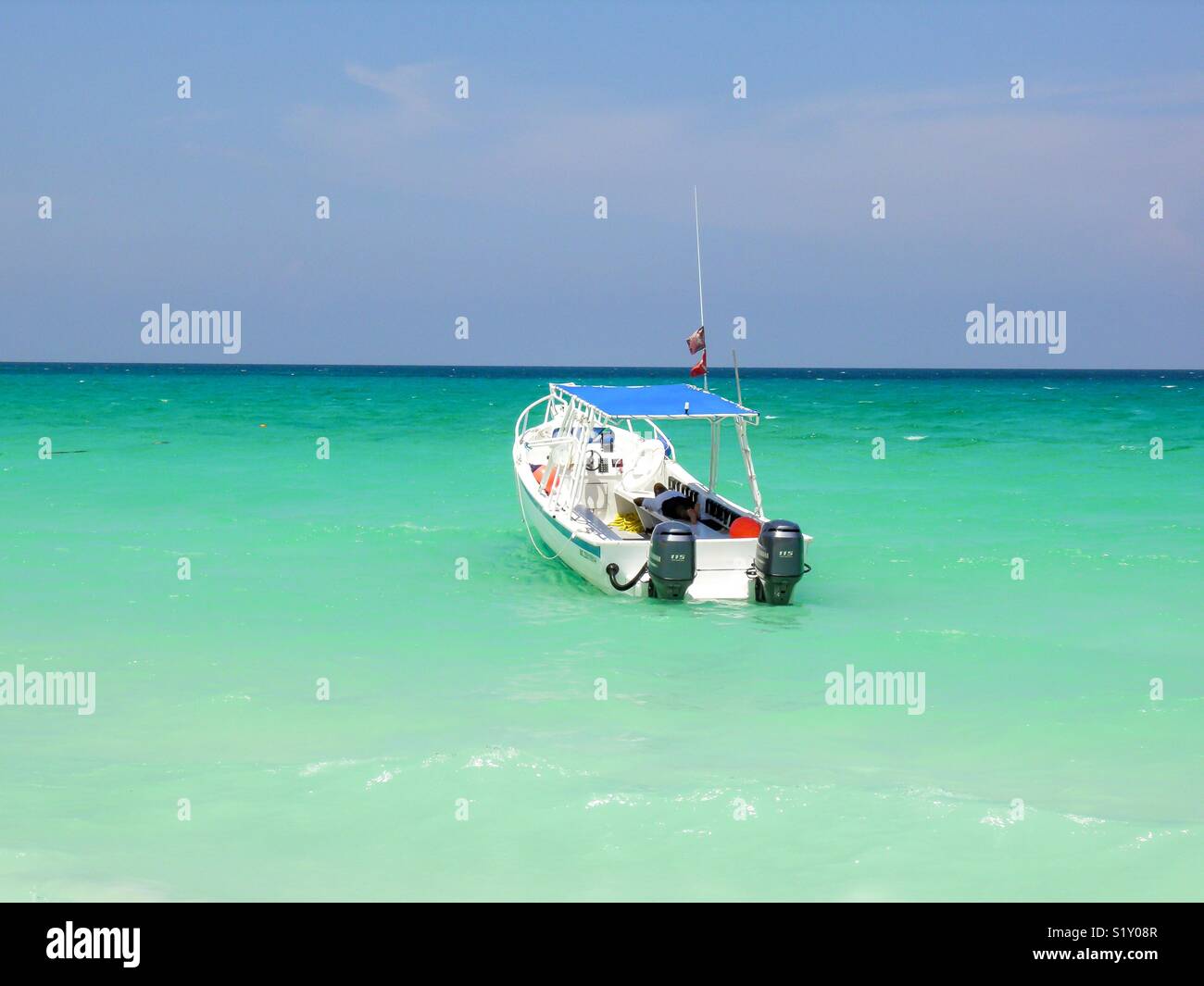 Fishing boat floating in the Caribbean Sea Stock Photo - Alamy