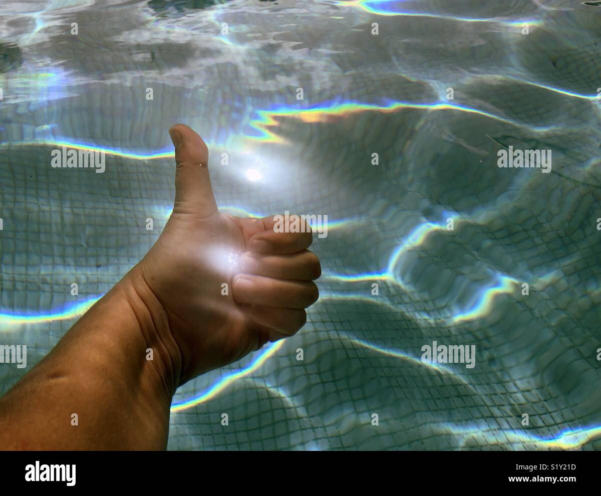 Thumbs up underwater Stock Photo - Alamy