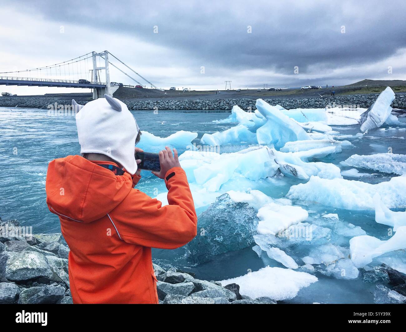Child looking at the glacier ice carried into the sea Stock Photo - Alamy