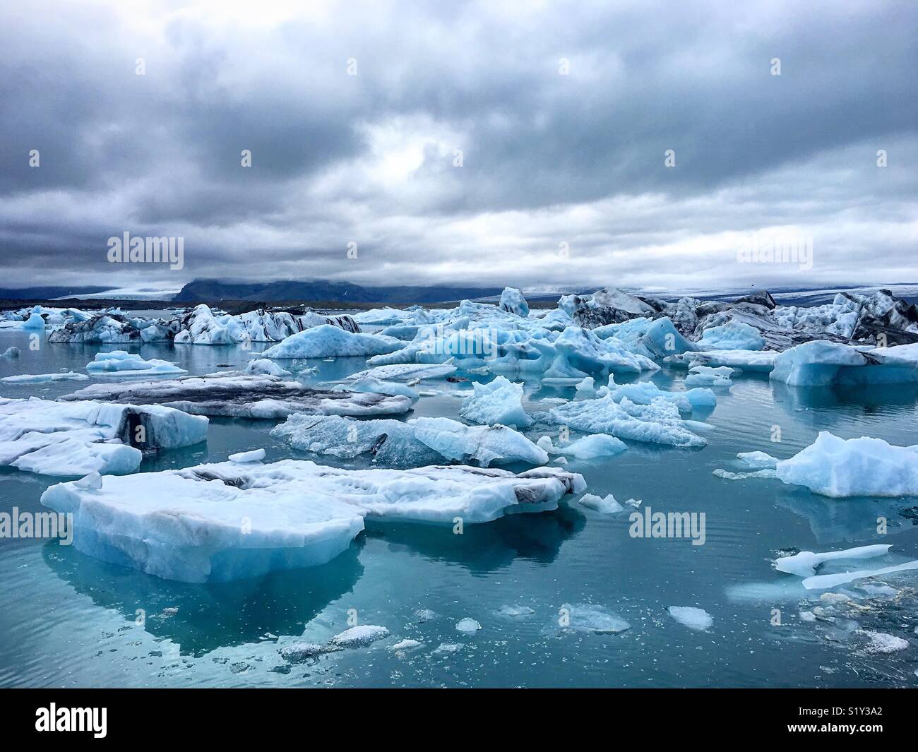Ice from the glacier floating into the ocean in Iceland Stock Photo - Alamy