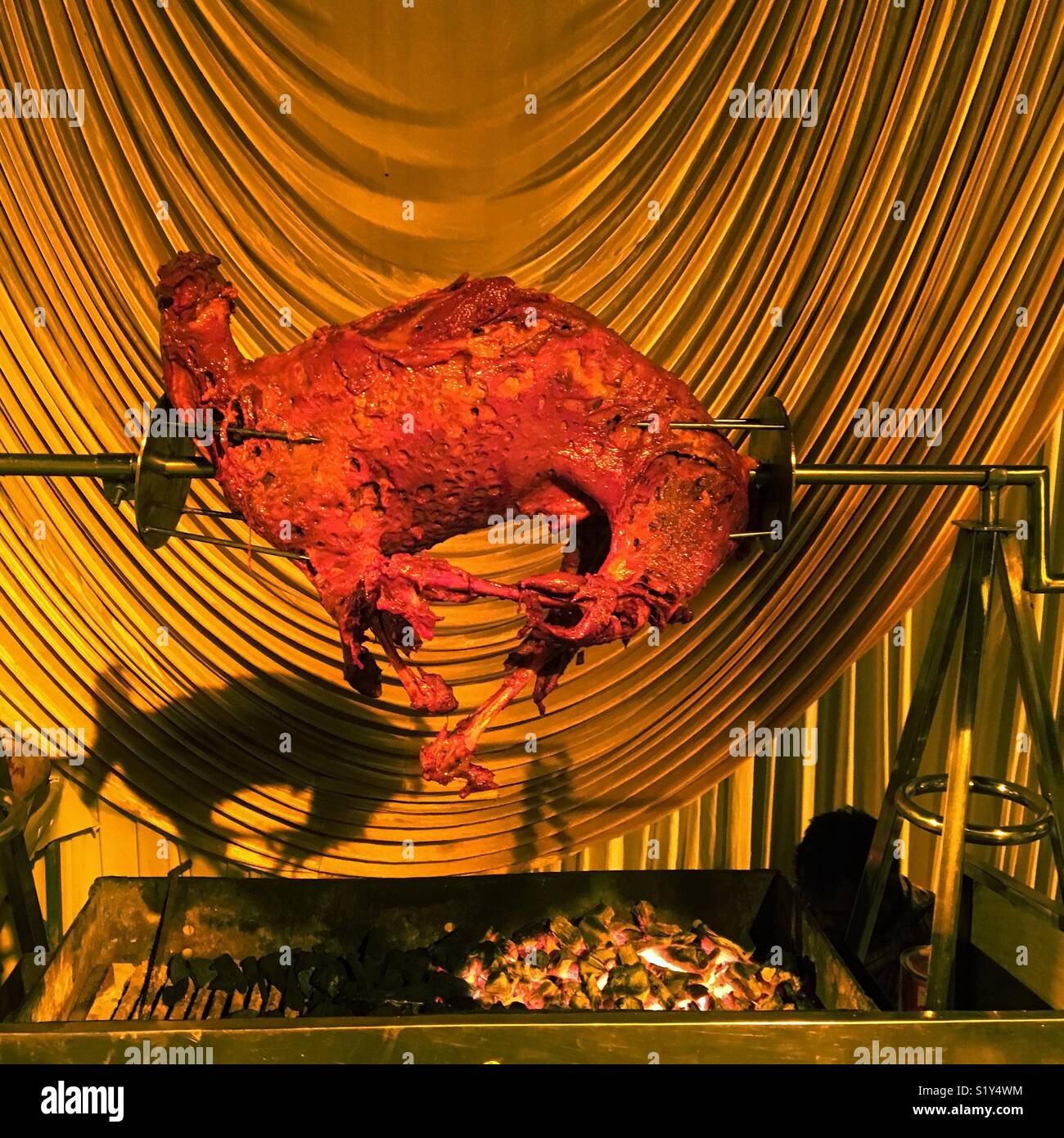 Grilled lamb on slow charcoal fire Stock Photo - Alamy