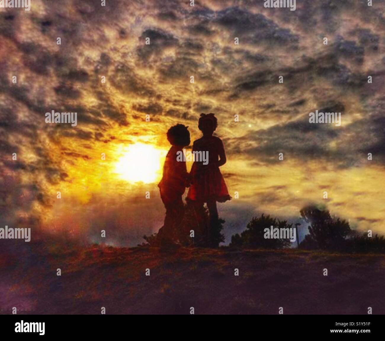 Children at sunset Stock Photo - Alamy