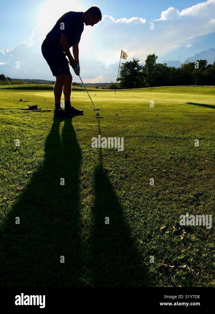 Golf in backlight. Will he play for a par Stock Photo - Alamy