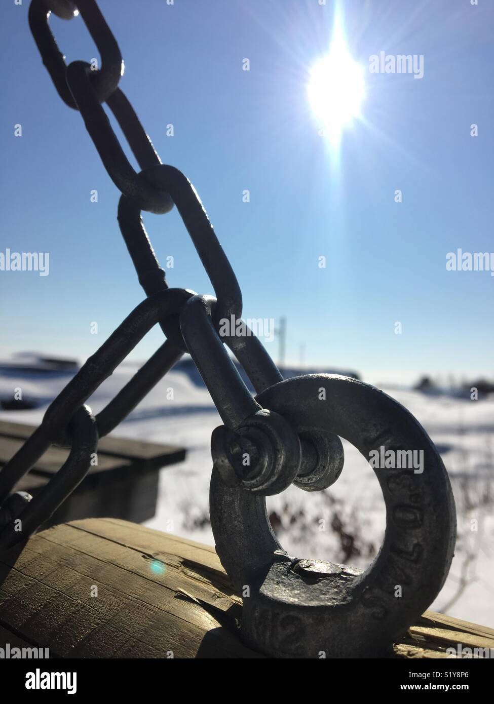 Chain with Sun in background Stock Photo - Alamy
