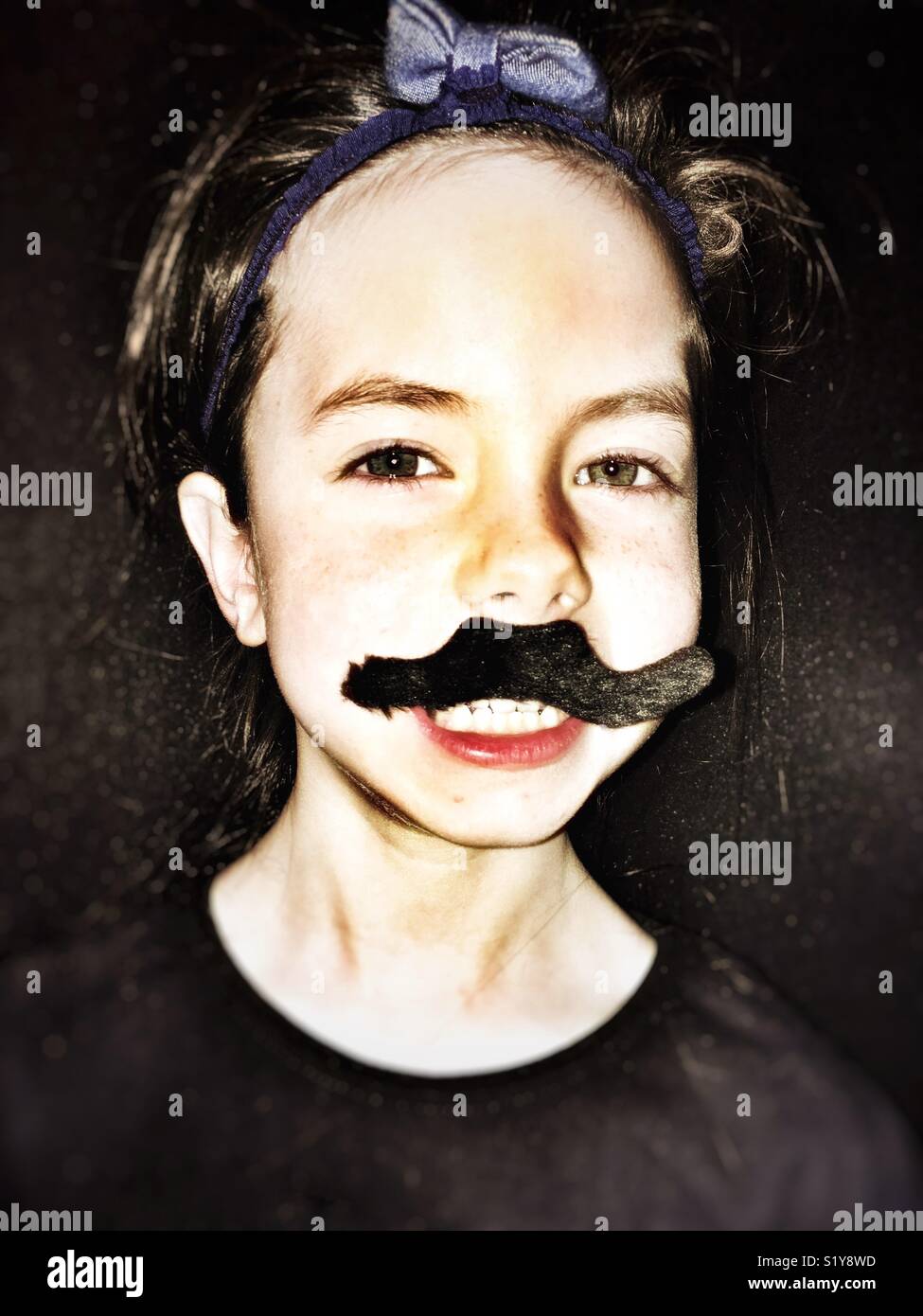 Girl wearing comedy moustache Stock Photo - Alamy