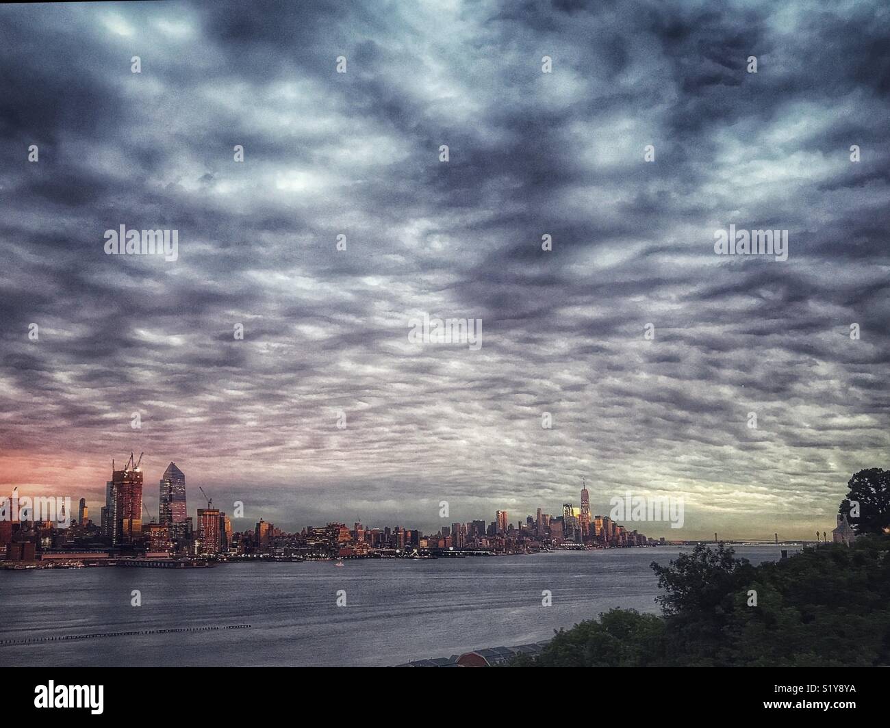 Sunset view manhattan downtown with dramatic clouds Stock Photo - Alamy