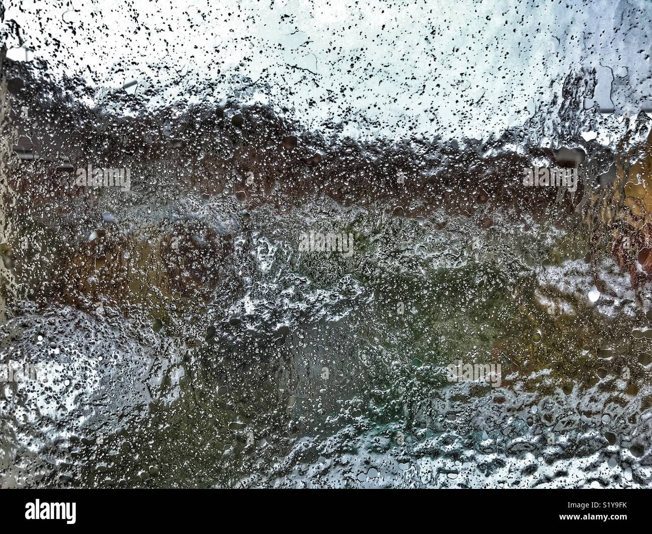 Freezing rain on the window of a house. Freezing rain is precipitation ...