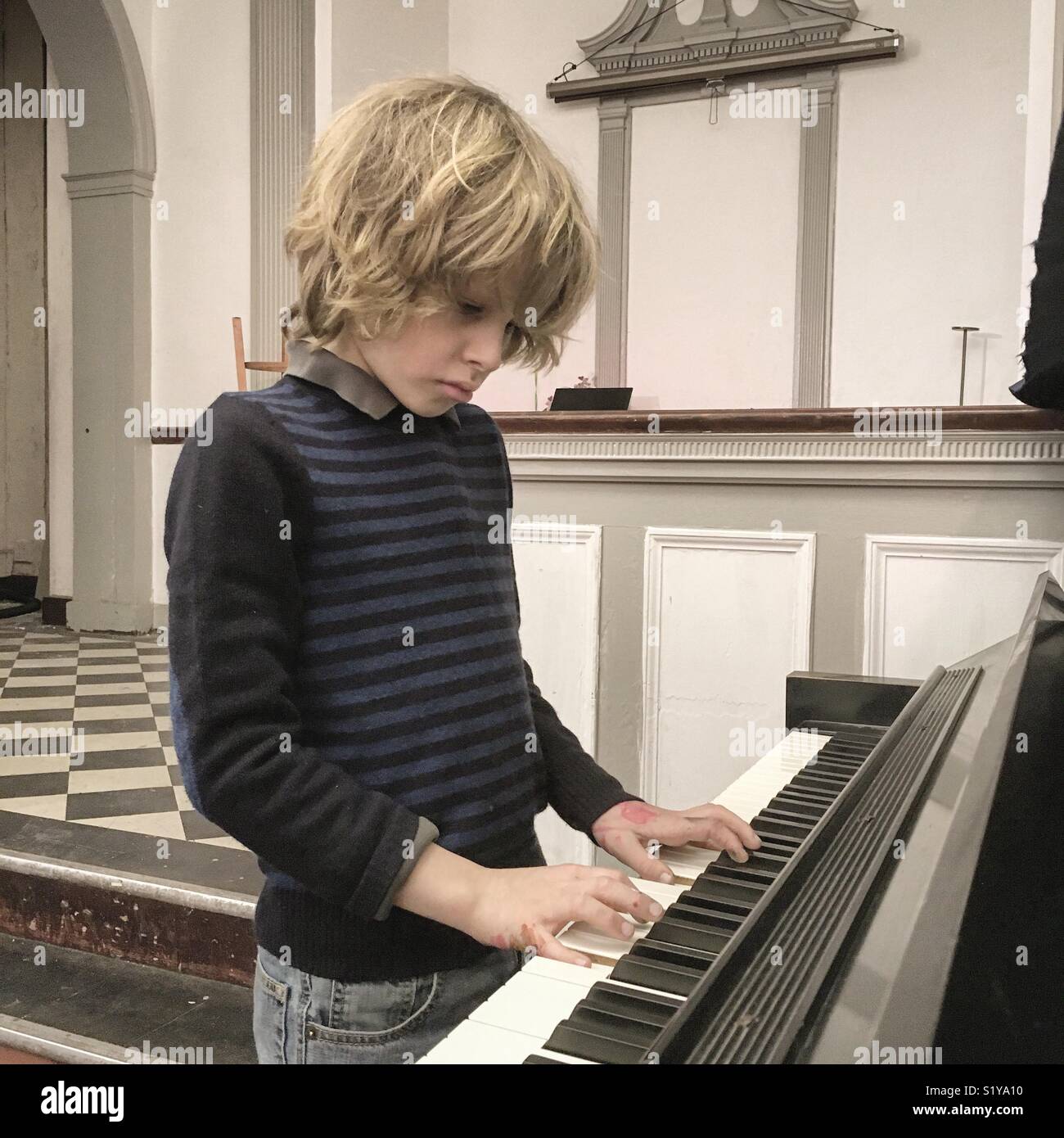 Boy playing piano hi-res stock photography and images - Alamy