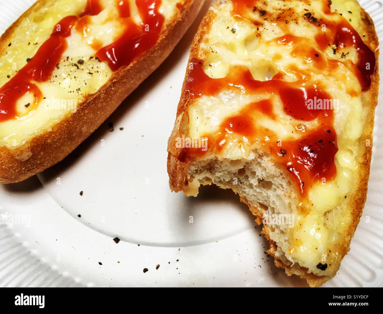 Toasted cheddar cheese on bread roll with tomato ketchup Stock Photo ...
