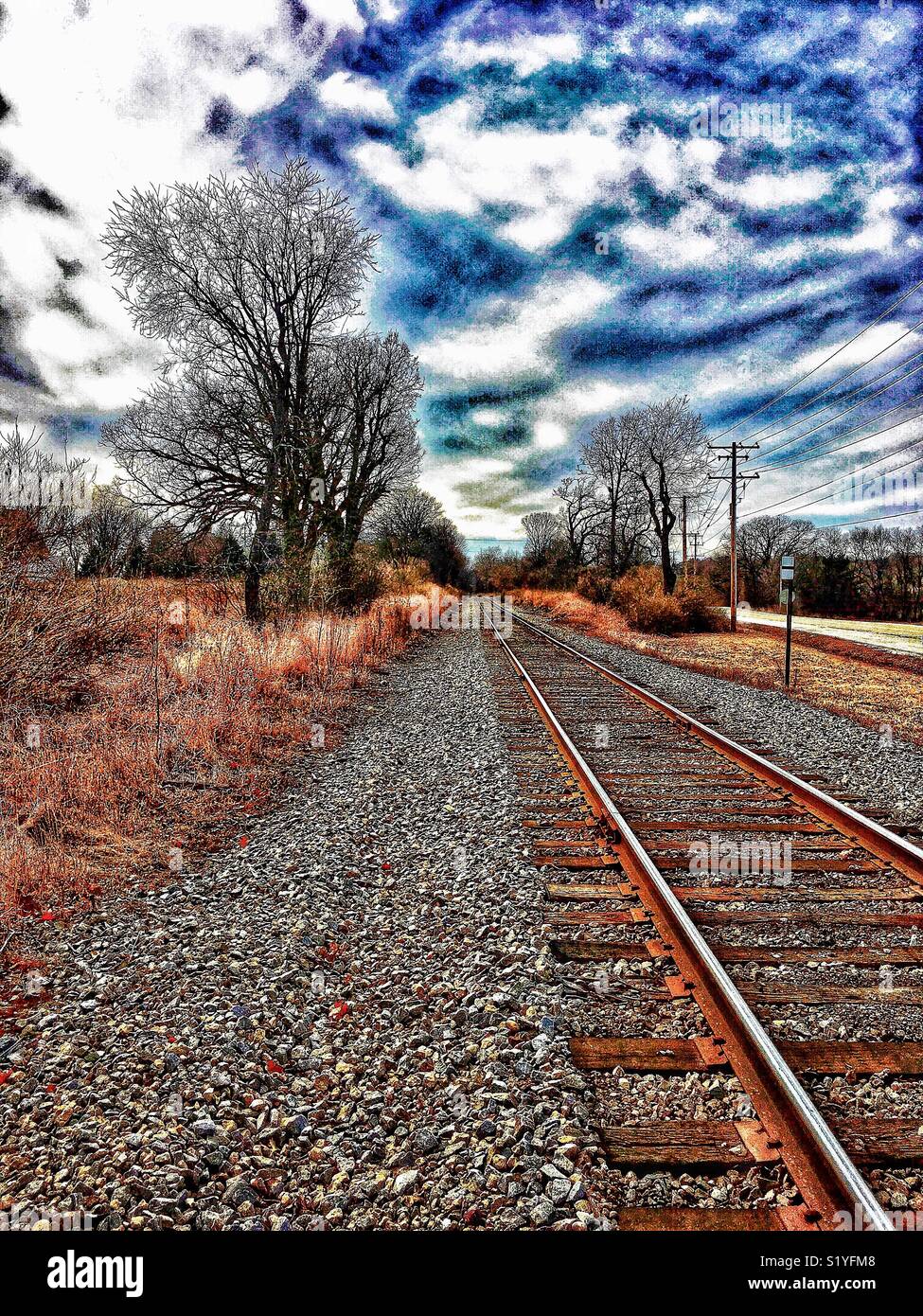 View of railroad tracks with dramatic sky Stock Photo - Alamy